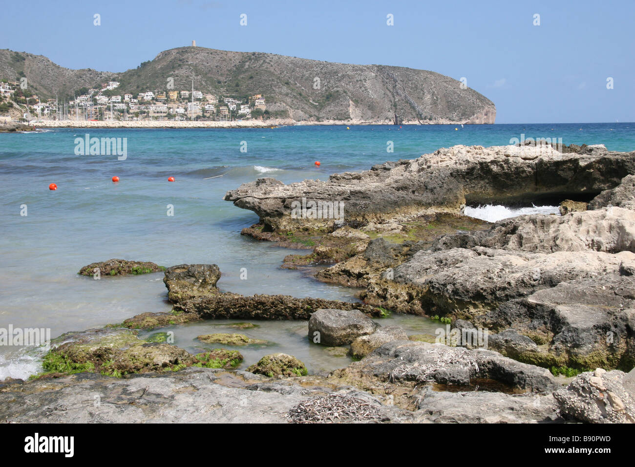 Harbor at Moraira, Teulada, Spain, with the tower Torre del Cap d'Or in ...