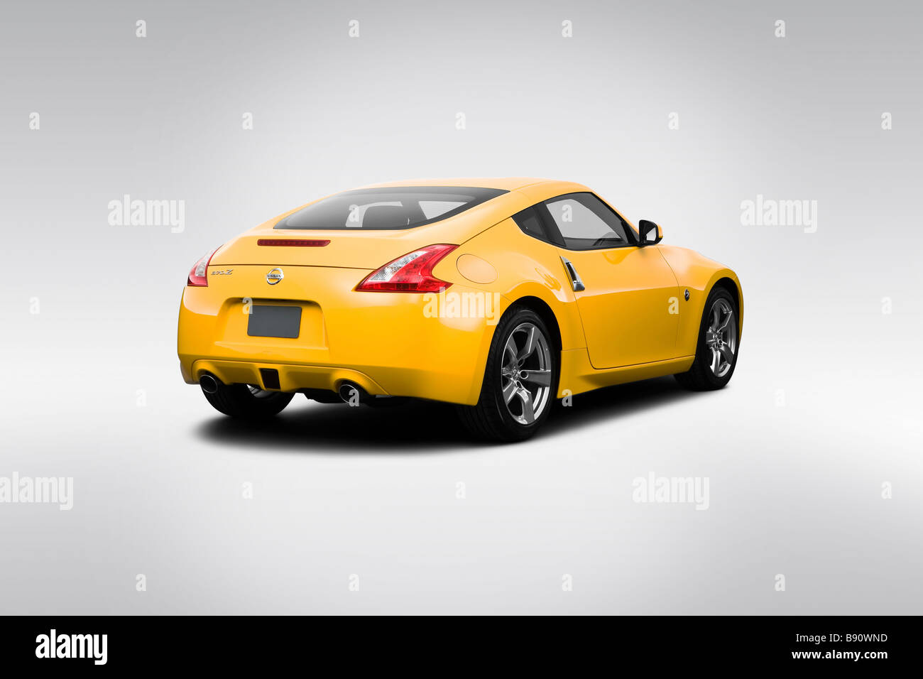 2009 Nissan 370Z in Yellow - Rear angle view Stock Photo - Alamy