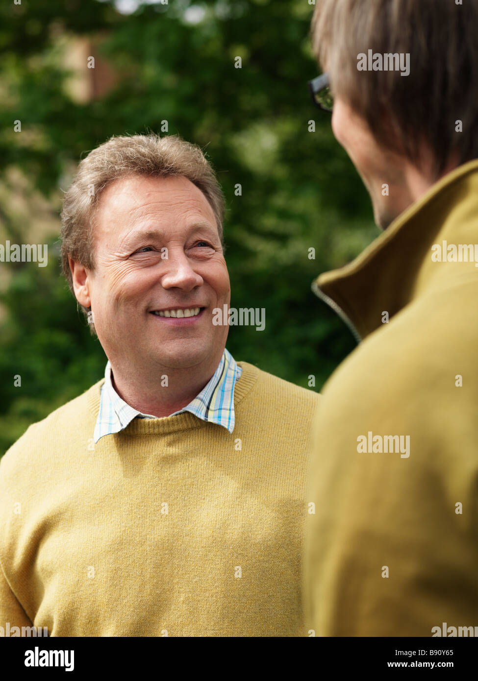 Two men talking Stock Photo - Alamy