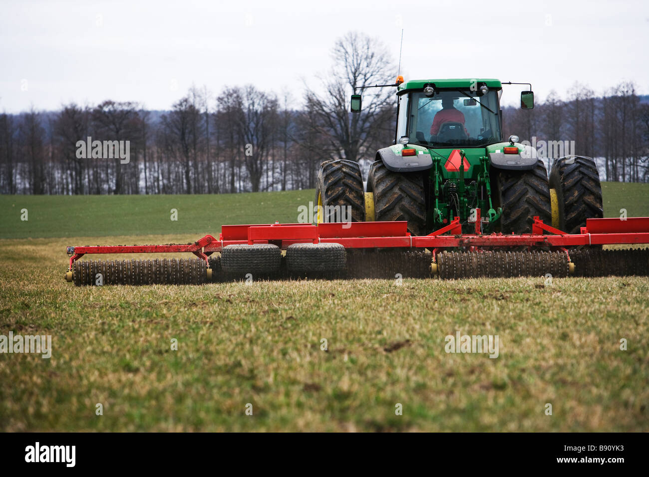 Tractor with roller in a field Sweden Stock Photo - Alamy