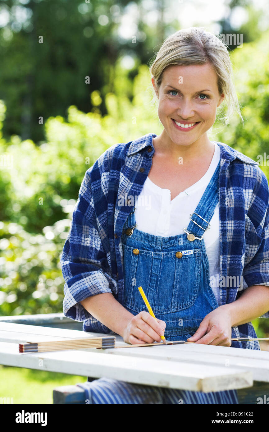 A woman doing carpentry in a garden Sweden Stock Photo - Alamy