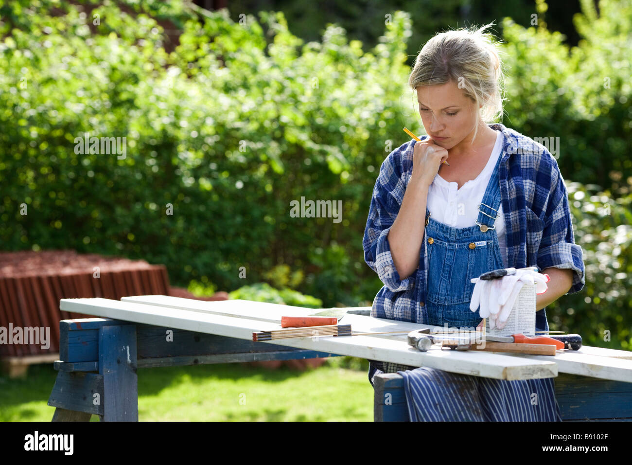 A woman doing carpentry in a garden Sweden Stock Photo - Alamy