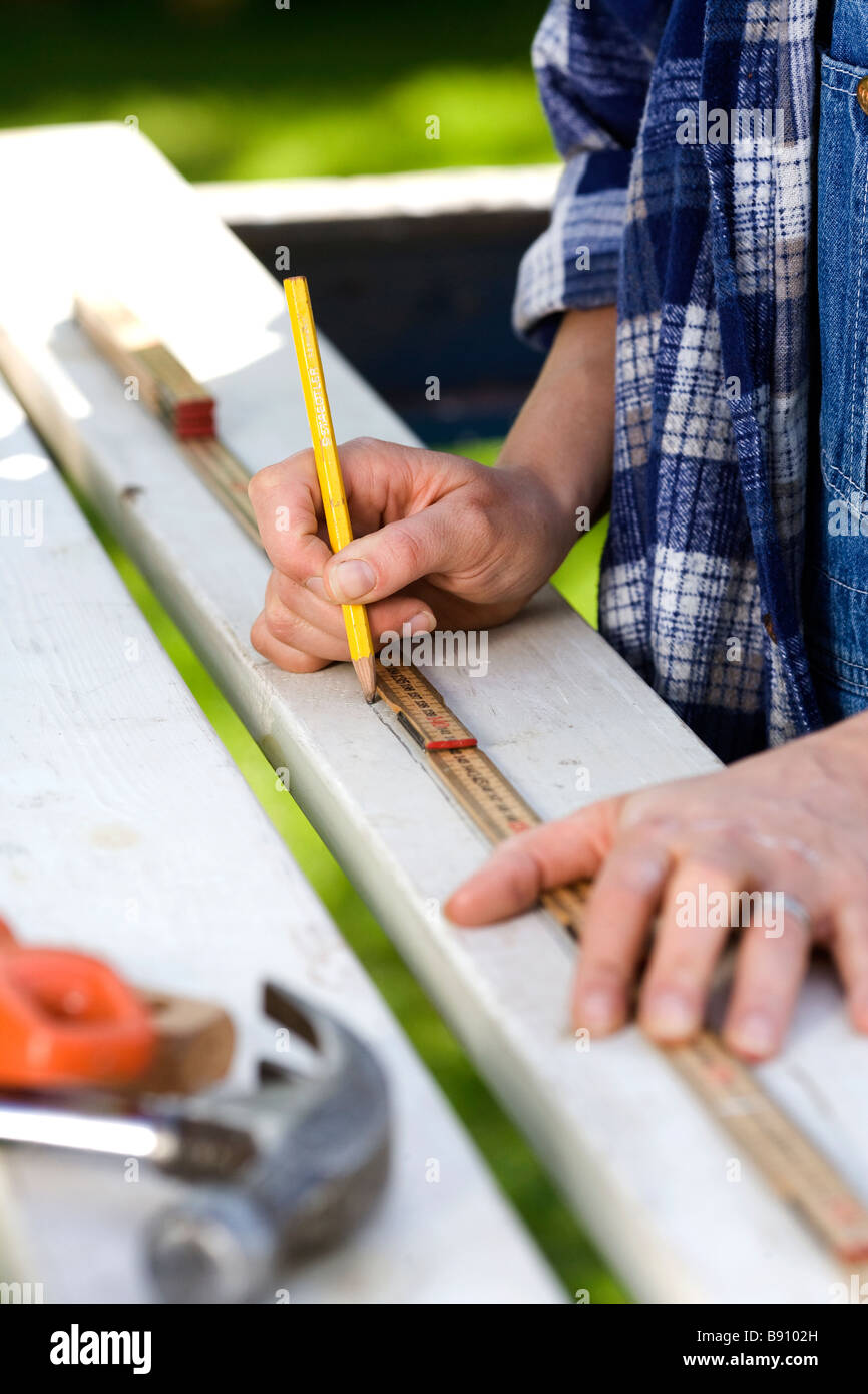 A woman doing carpentry in a garden Sweden Stock Photo - Alamy