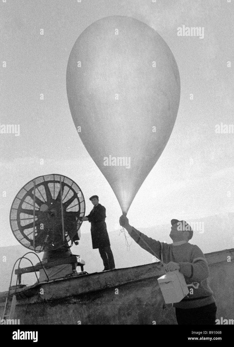 An aerologist launching a radio balloon at an aerological station in ...