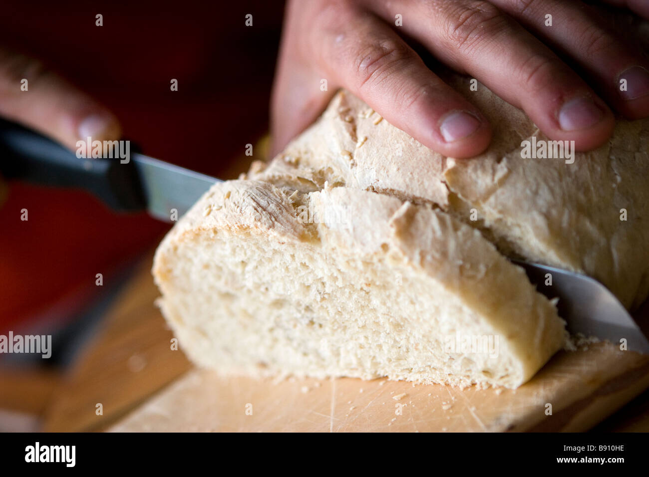 A man slicing bread Sweden Stock Photo - Alamy