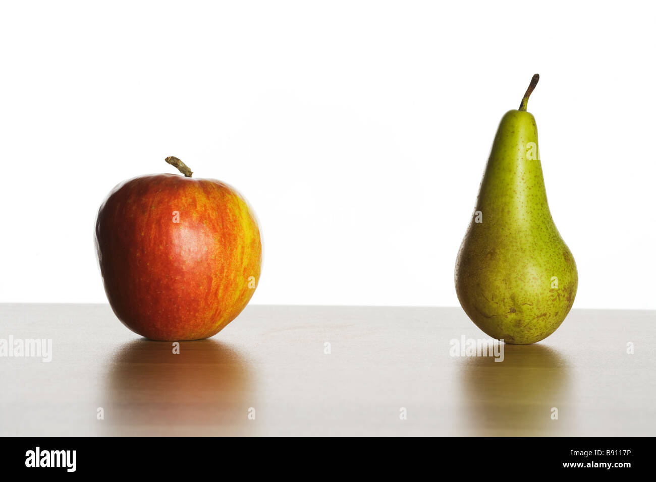 An apple and a pear Stock Photo - Alamy
