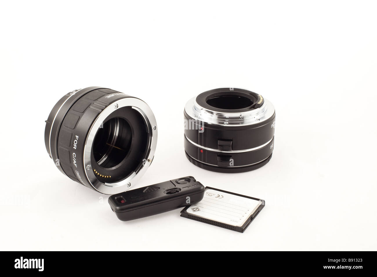 Two photo lens remote control and compactflash on a white background ...