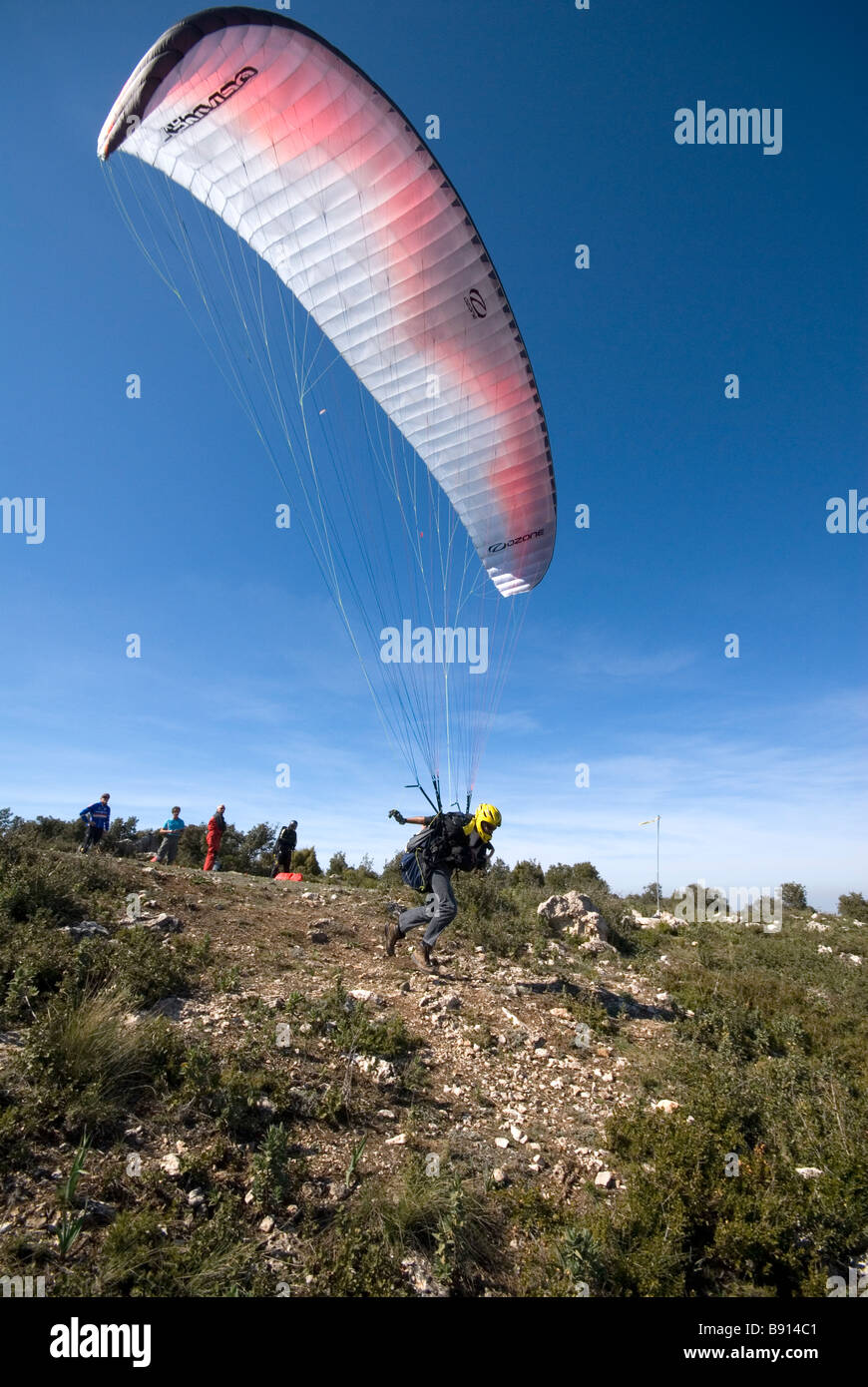Paraglider launching from hilltop Stock Photo - Alamy