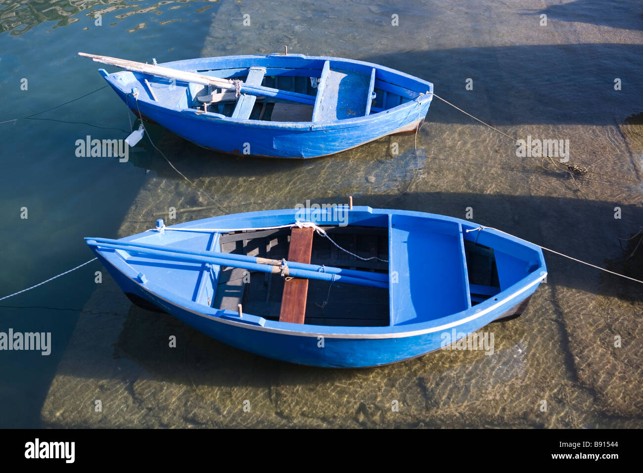Two blue painted rowing boats Gallipoli, Southern Italy Stock Photo - Alamy