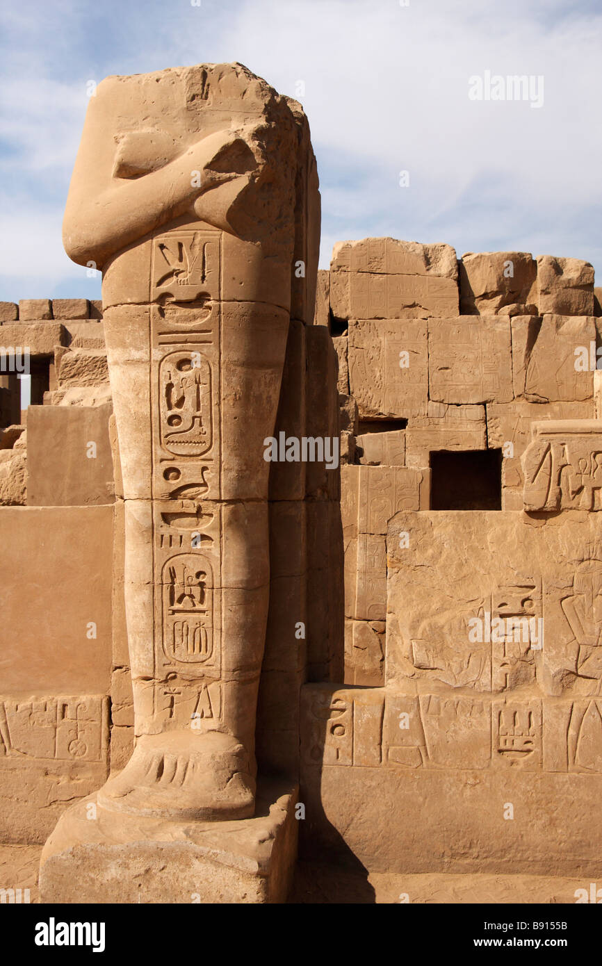 Headless osiris statue of an Egyptian pharaoh carved with hieroglyphics ...