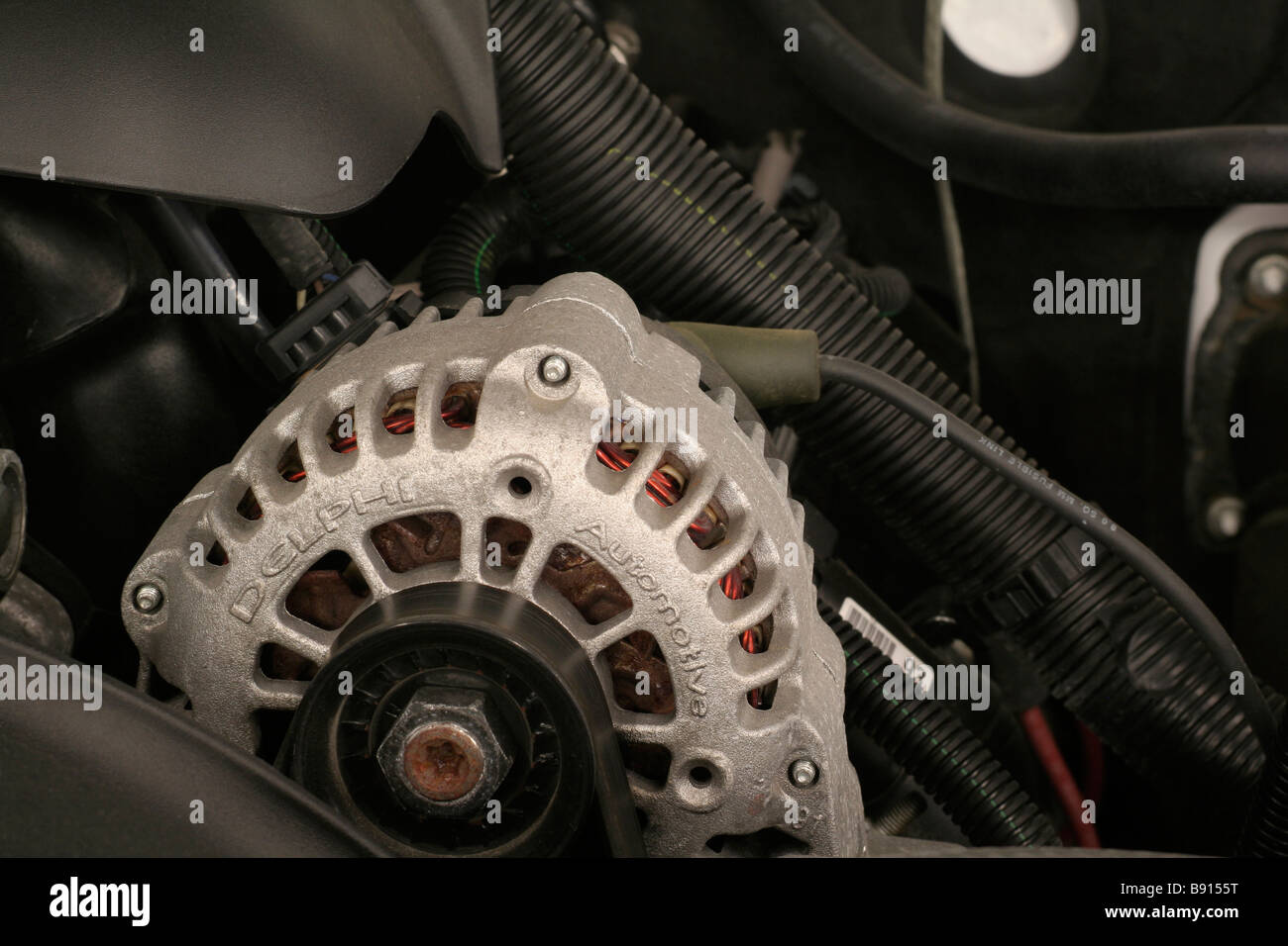 Delphi automotive alternator installed on new engine Stock Photo - Alamy