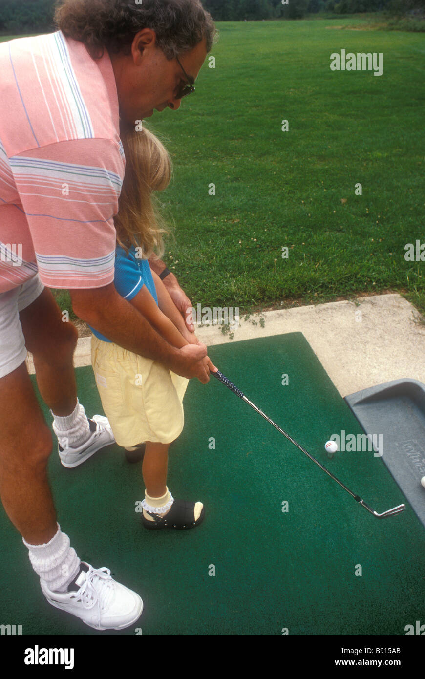 Teaching a child Golf Stock Photo - Alamy