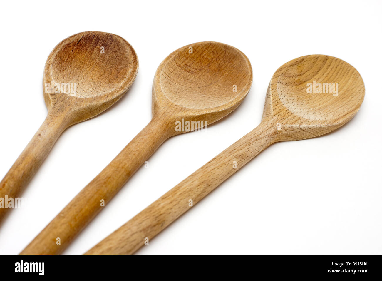 Three wooden spoons on a white background Stock Photo - Alamy