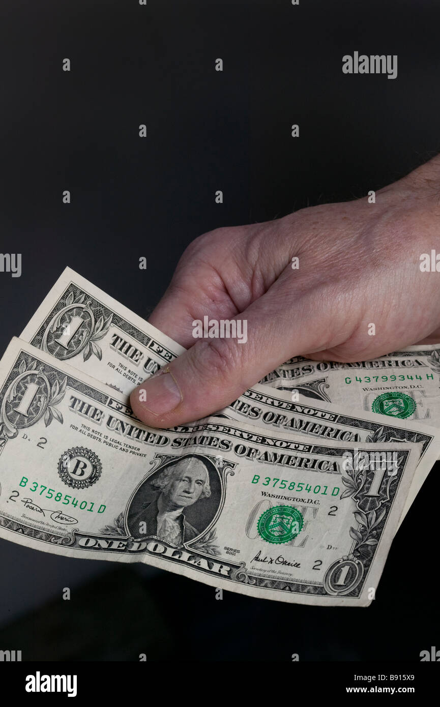 A male hand holding dollar bills Stock Photo - Alamy