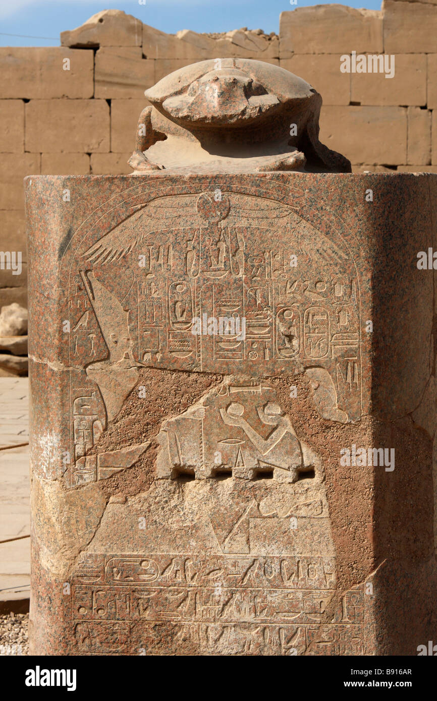 Sacred scarab beetle statue, stone plinth carved with hieroglyphics ...