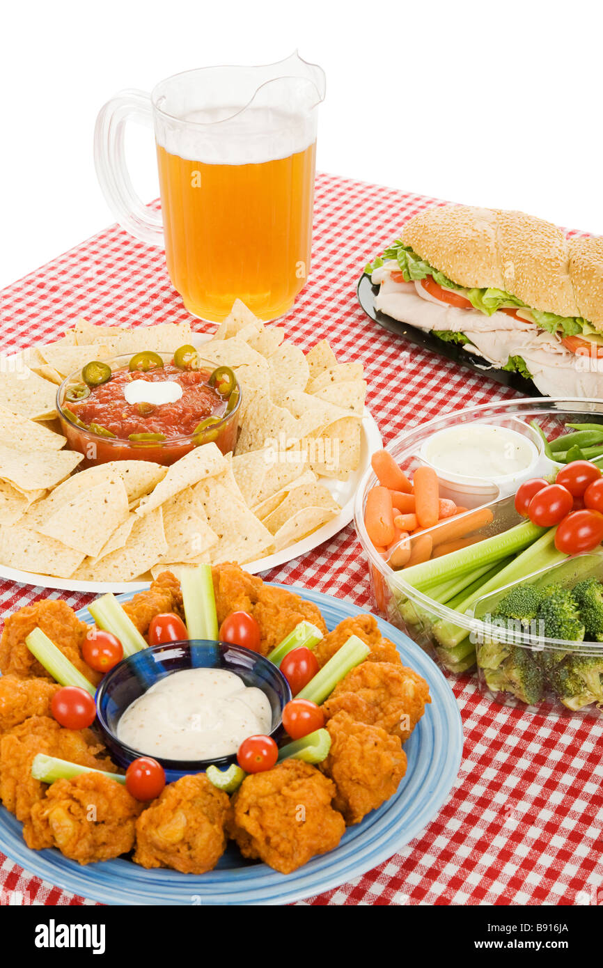 Table set with party snack food platters and a pitcher of beer Stock ...