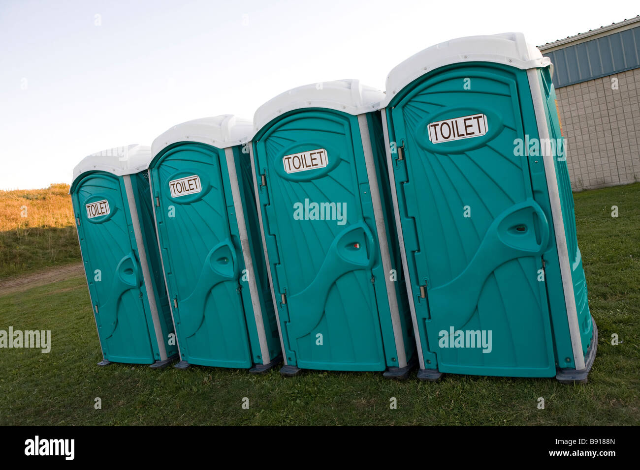 Portable toilet outhouses in a sport event field Stock Photo - Alamy
