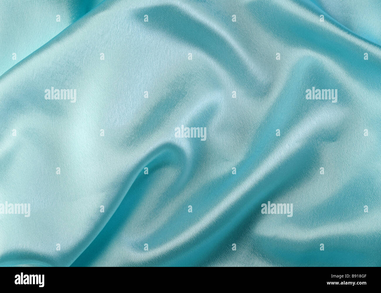 blue satin background A satiny fabric with beautiful light shadow waves ...