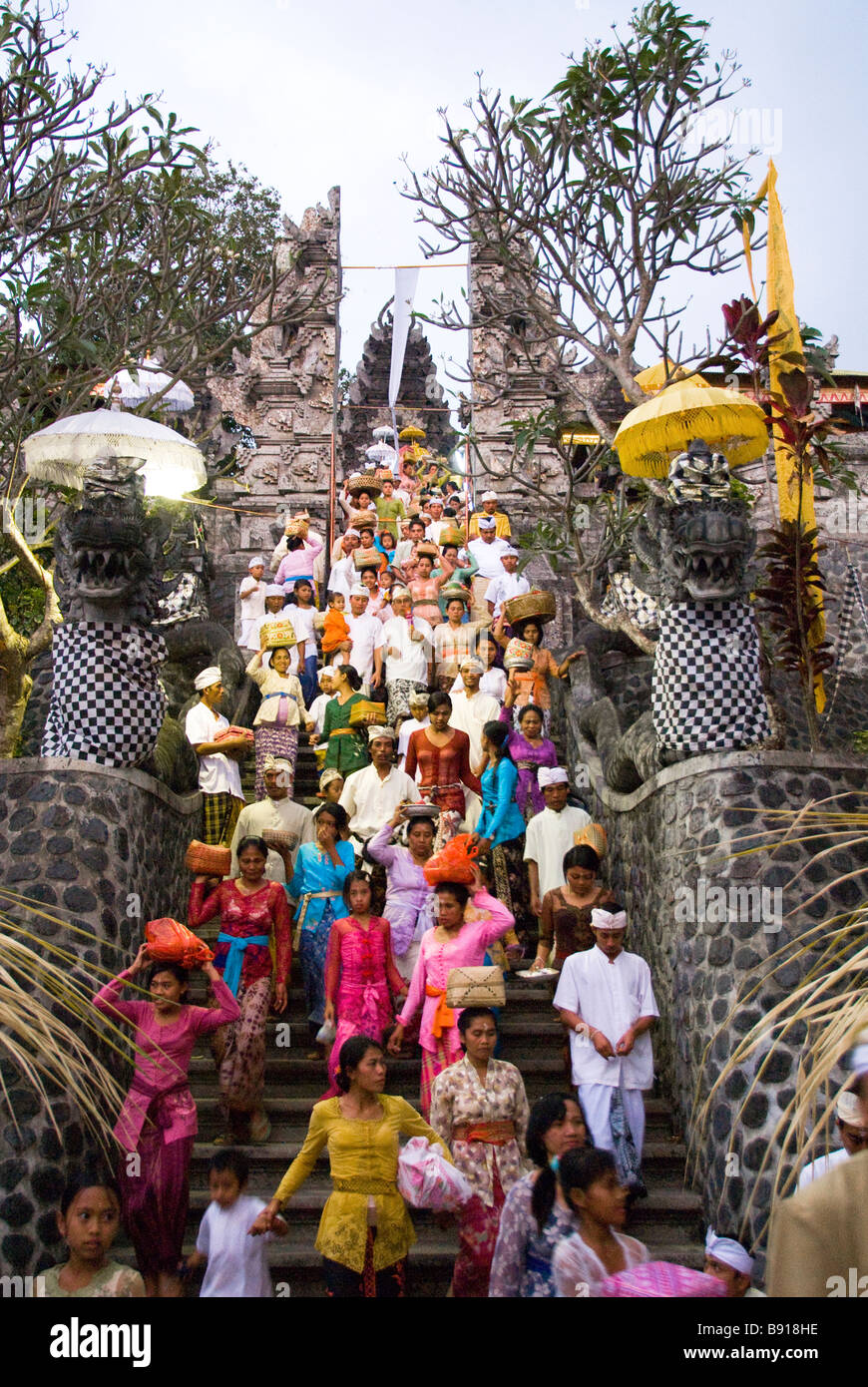 Balinese folks walking down from temple stairs after praying and giving ...