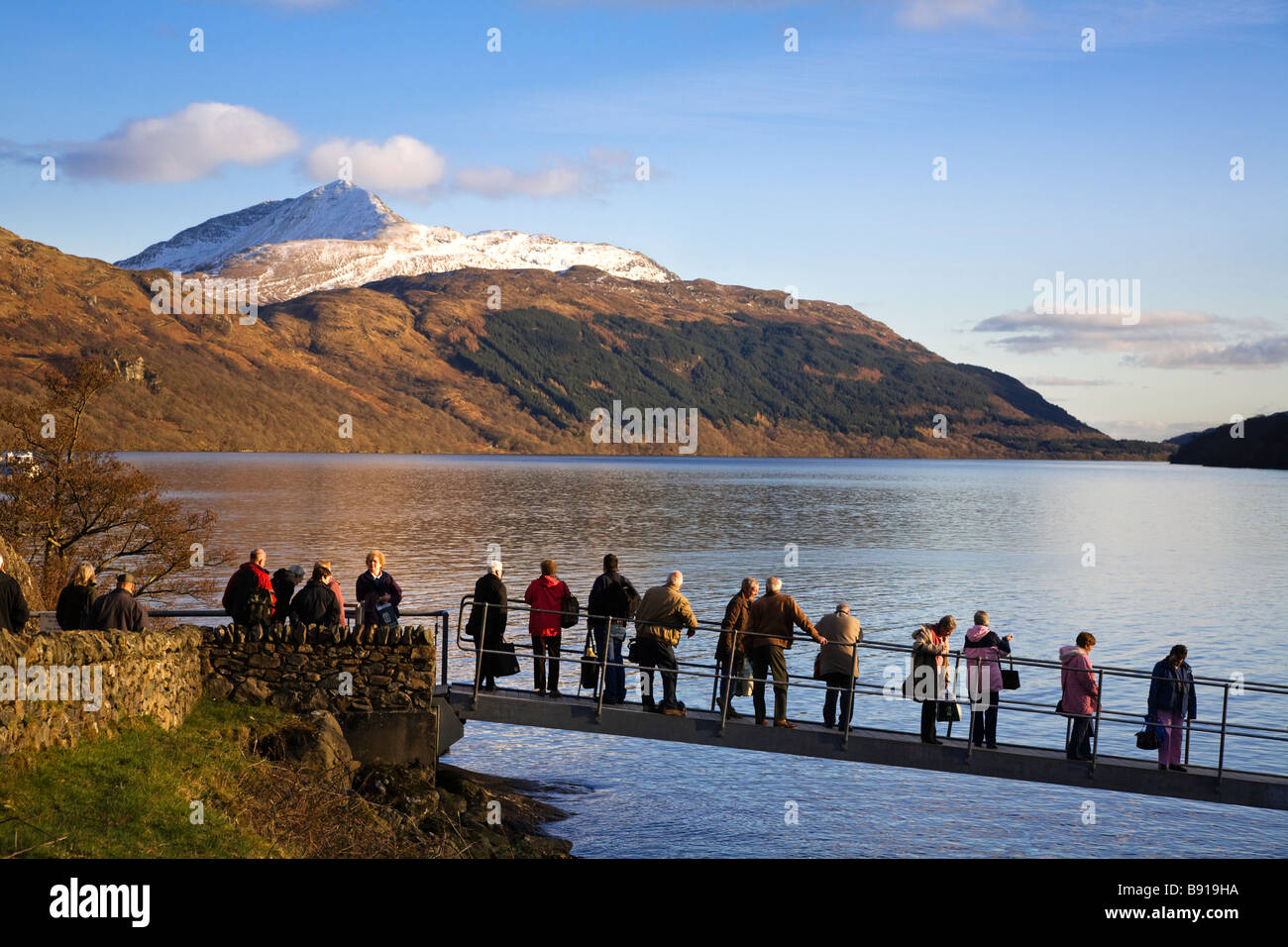 People queueing on a gangway waiting for the Inversnaid hotel ferry ...