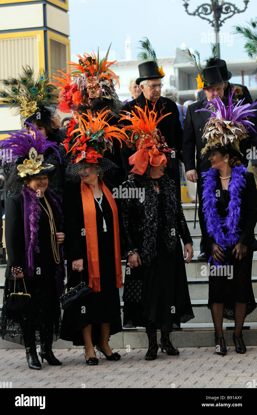 Widows and widowers dressed in black prepare to join the Funeral of the ...