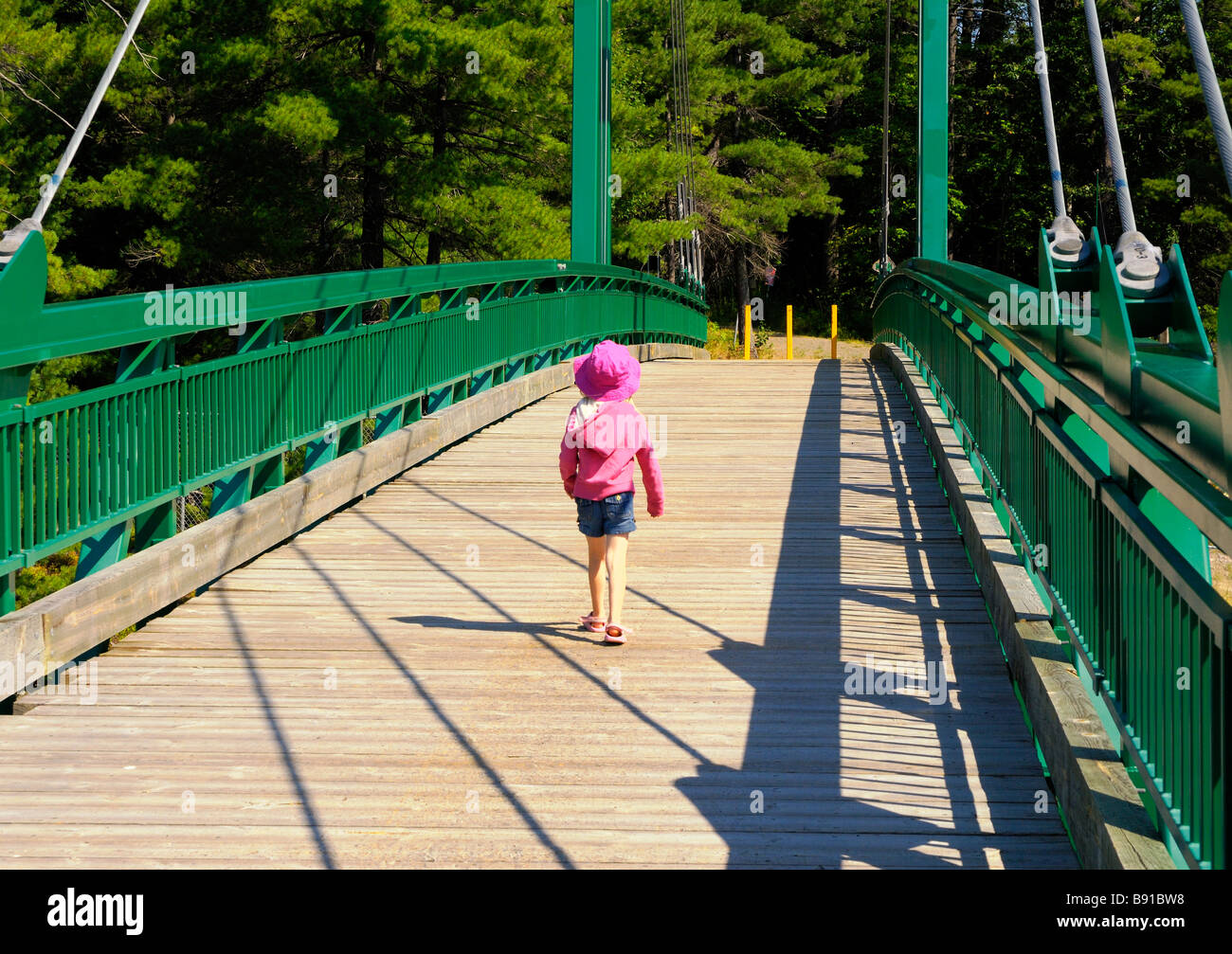 A little girl walking across the snowmobile bridge over the French ...