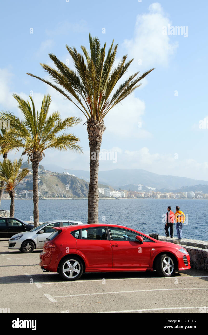 Red saloon car parked in a car park Stock Photo - Alamy