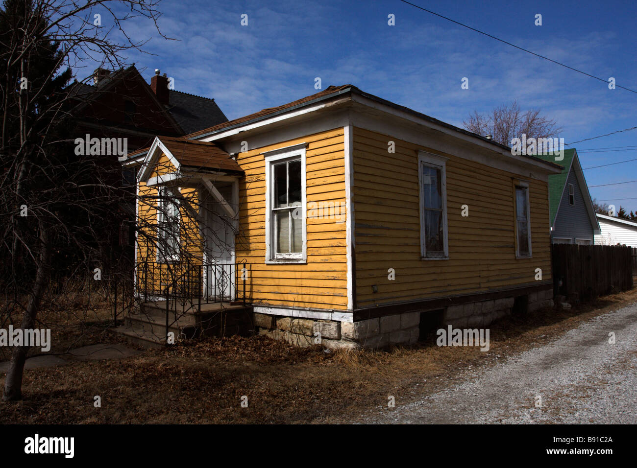 Small yellow house, corner front and alley Stock Photo - Alamy