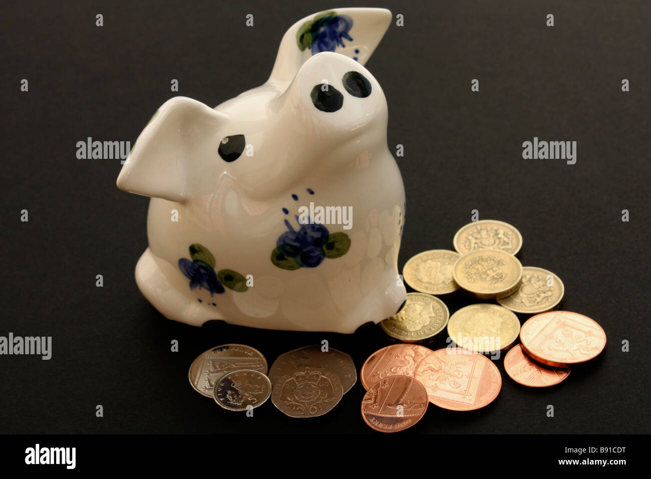 Coins in piggy bank hi-res stock photography and images - Alamy