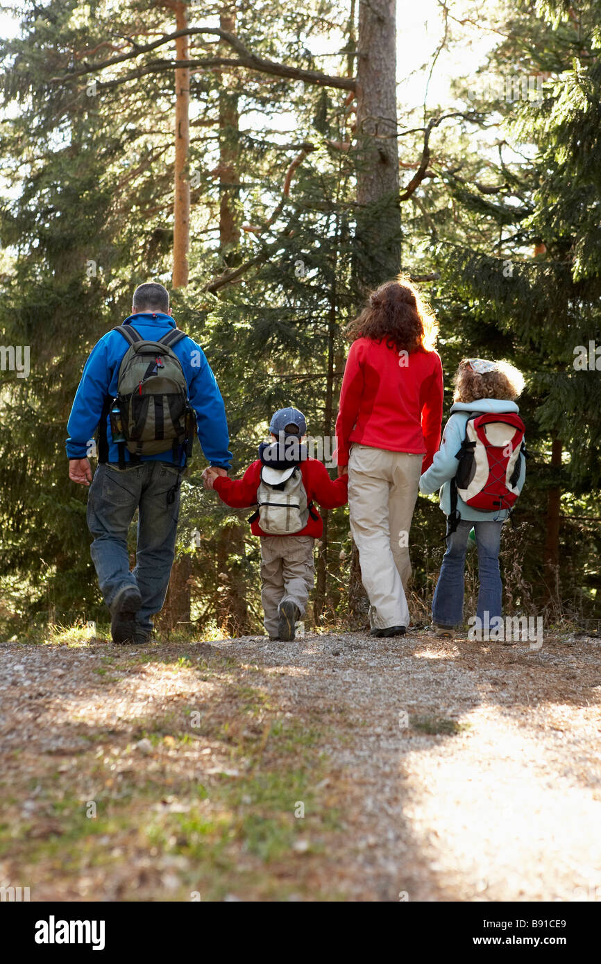 active family walking in a forest Stock Photo - Alamy