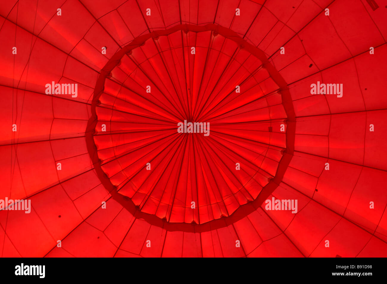 Inside an inflated colourful red [hot air balloon], close up detail ...