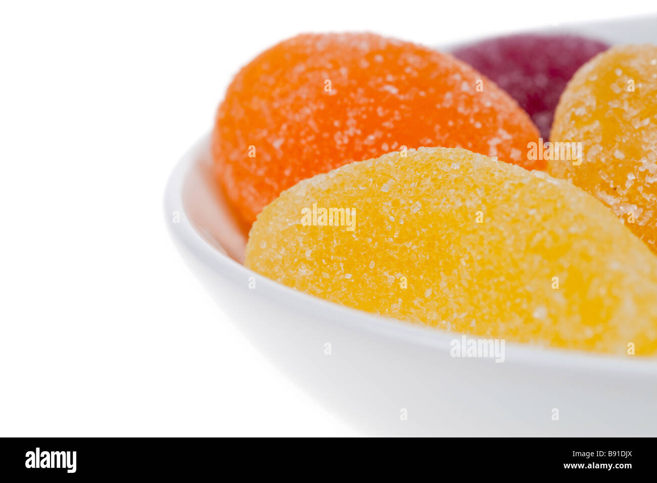bowl of fruit candy in many colors isolated on a white background Stock ...