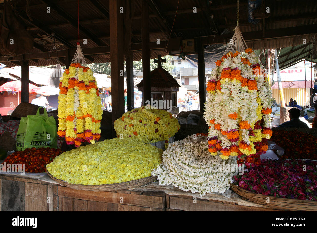 Flower garlands on display in a local market near Mobor in Goa, India ...