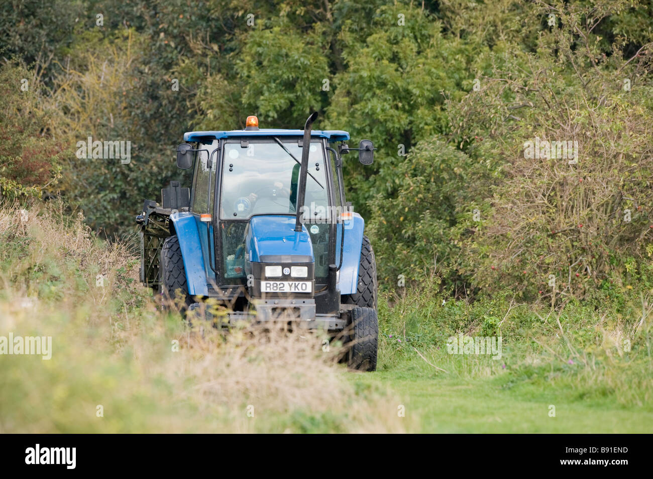 Tractor in the trees Stock Photo - Alamy