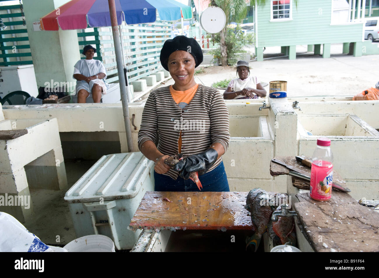A lady guts fish and prepares them for market in St John s the main ...