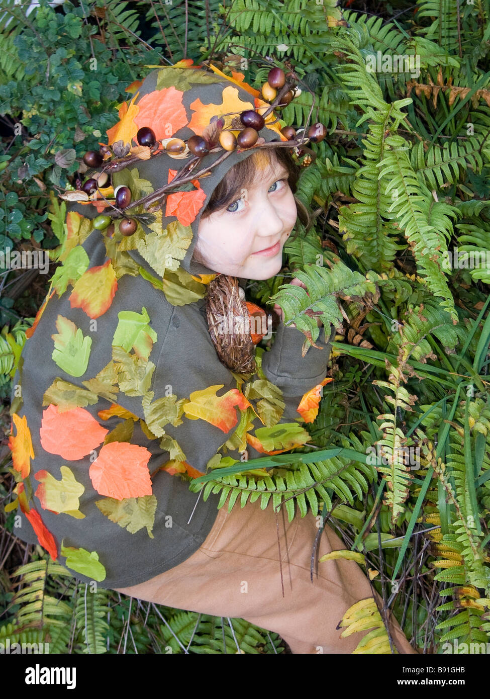 Girl hiding in bushes Stock Photo - Alamy