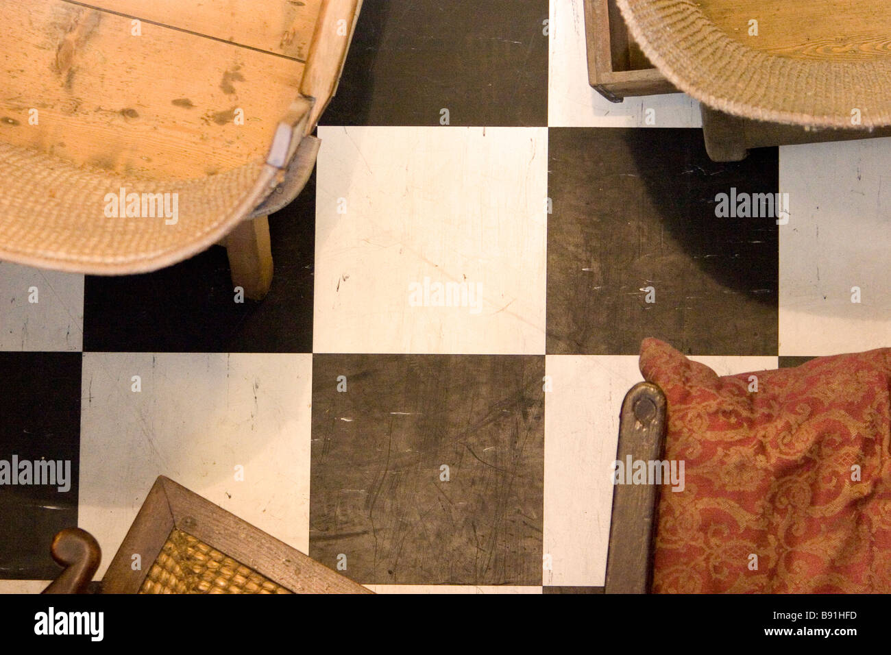Abstract aerial view of parts 4 old wood chairs against a checkerboard ...