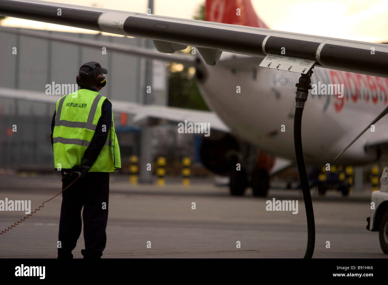 image of an airplane re fueler gassing up a plane Stock Photo - Alamy