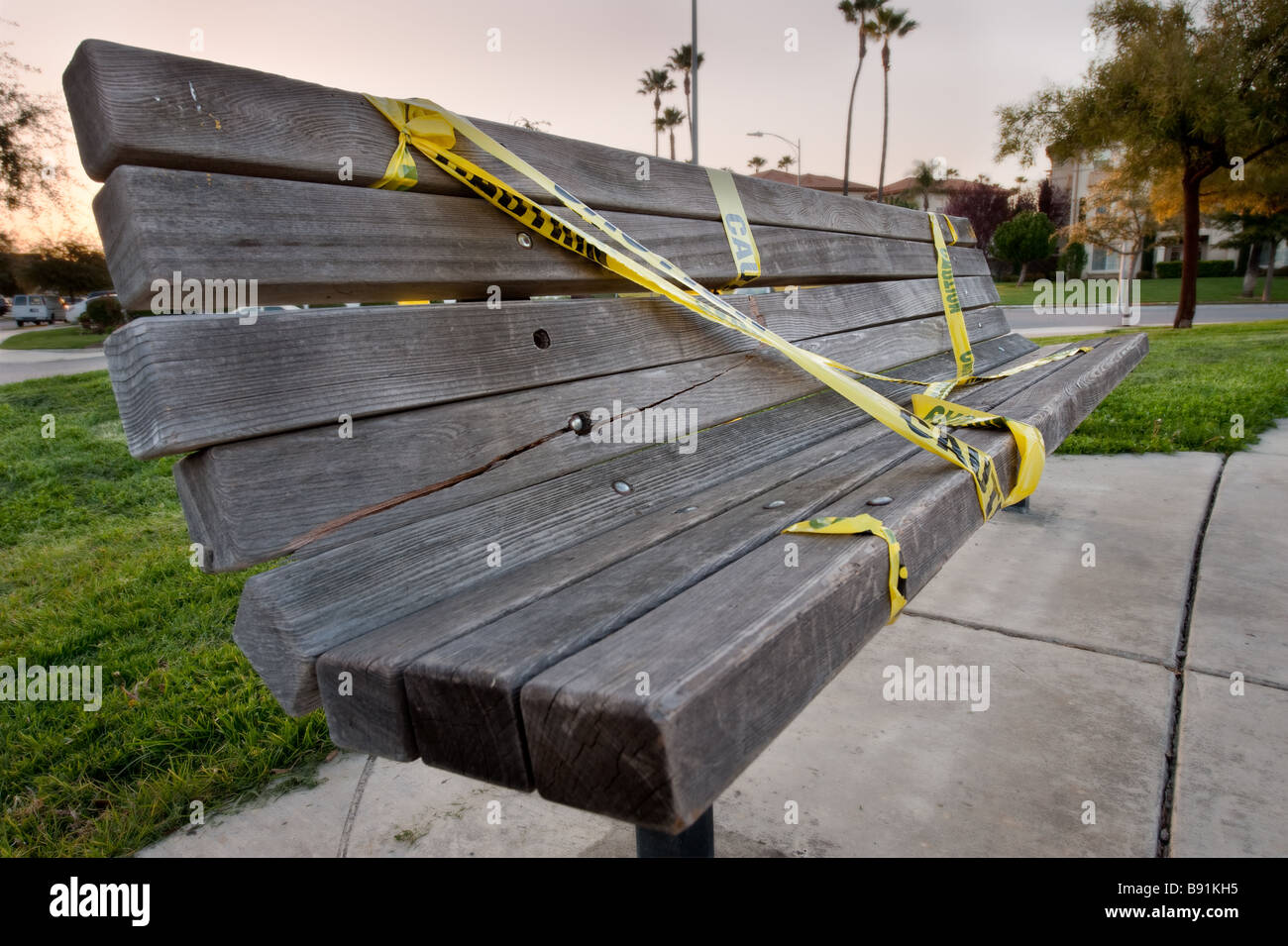 Damaged Park Bench with "caution tape" wrapped around it Stock Photo ...