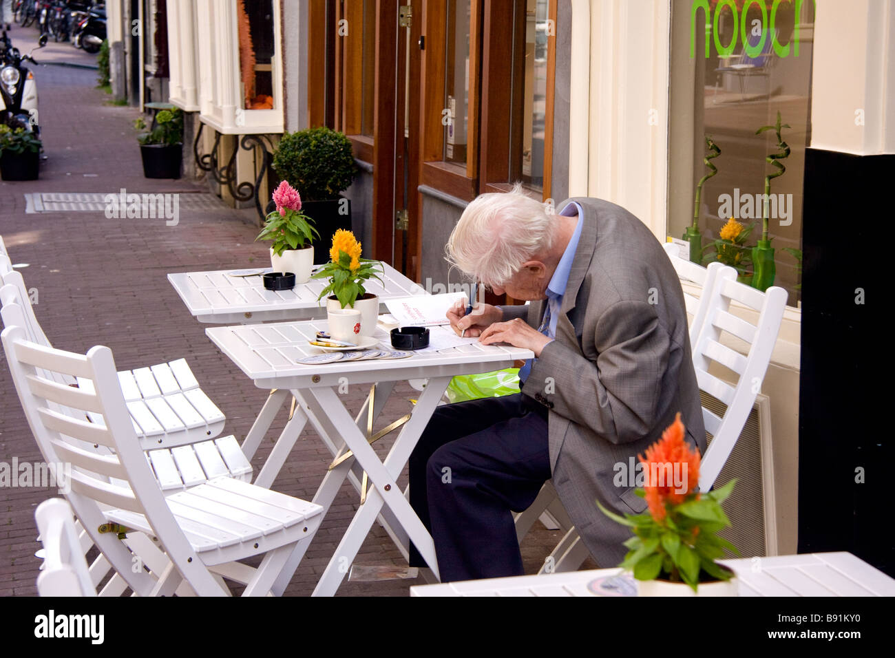 Old man writing cafe table hi-res stock photography and images - Alamy