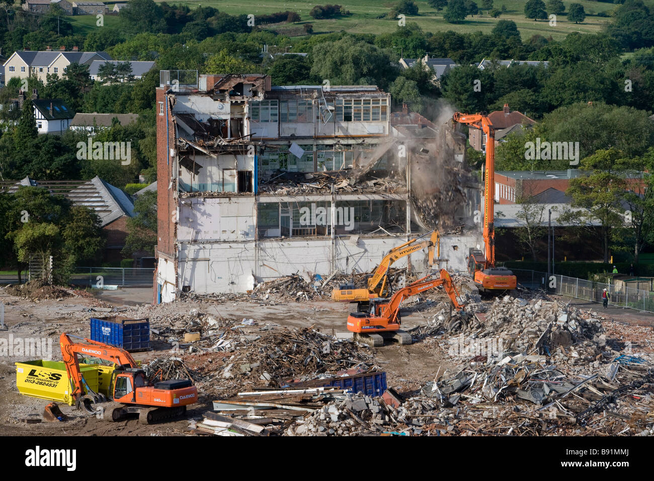 High view of demolition site (empty factory shell, heavy tracked ...