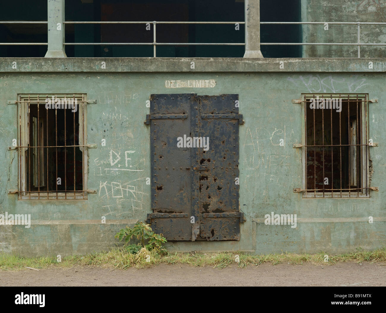 military ruins with iron door and two barred windows Stock Photo - Alamy