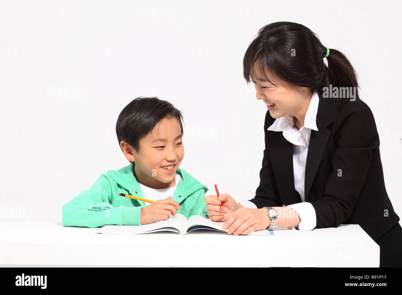 Child and Teacher in Study Stock Photo - Alamy