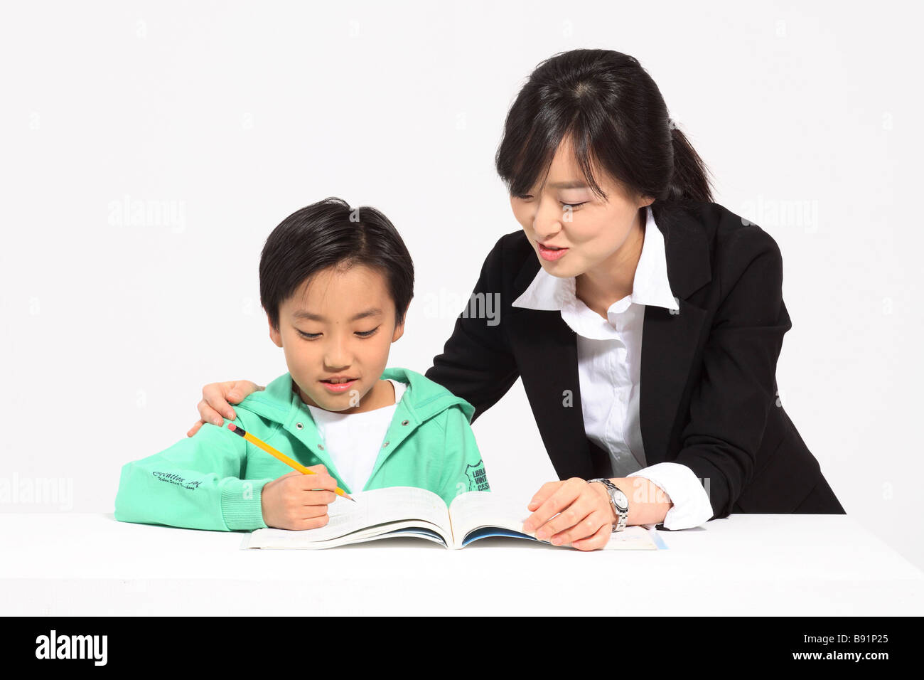 Child and Teacher in Study Stock Photo - Alamy