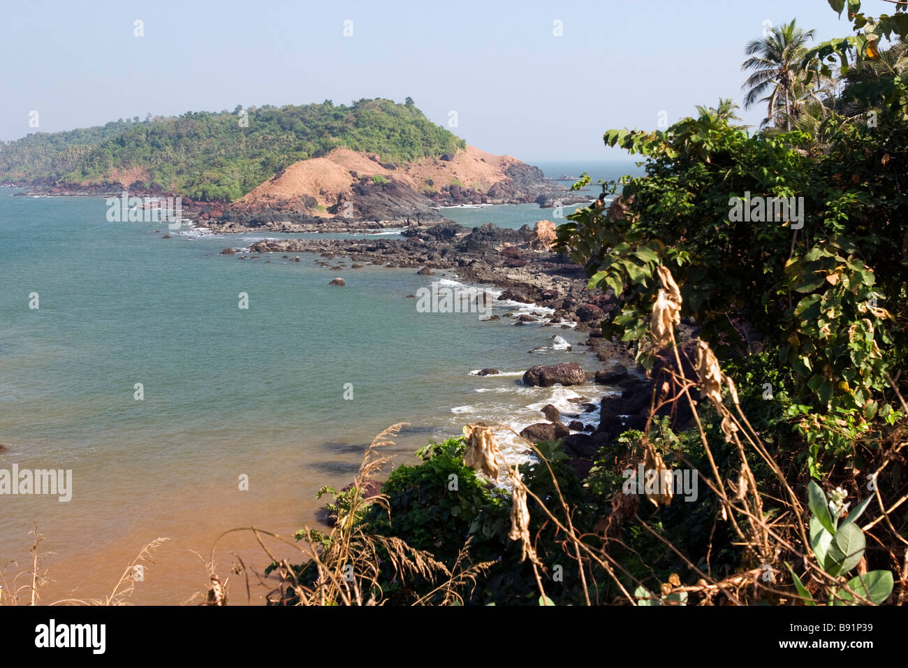 View on rocky cape and island in Indian Ocean, Goa, India Stock Photo ...