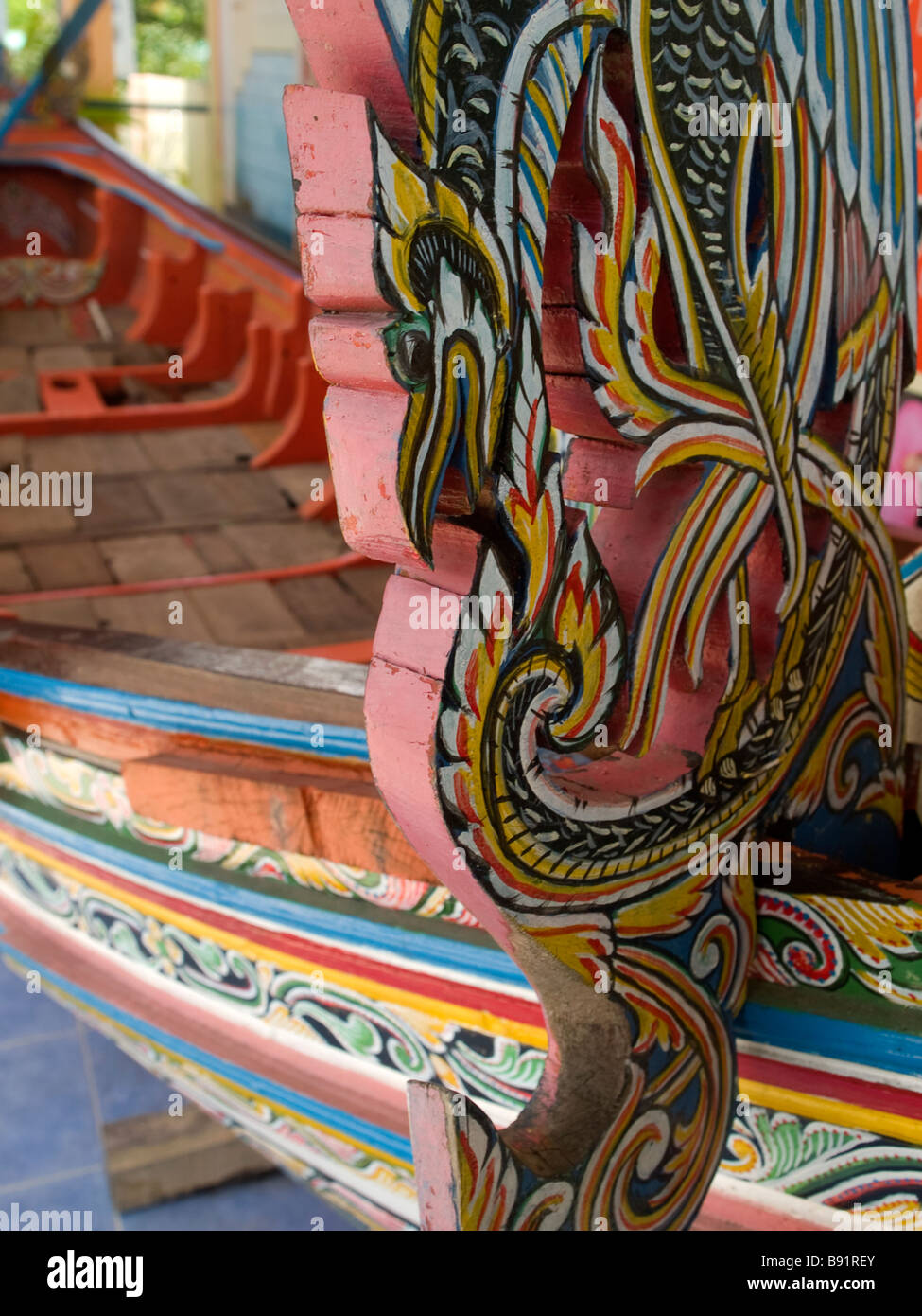 a detail of a traditional Malaysian boat with its brightly-painted ...