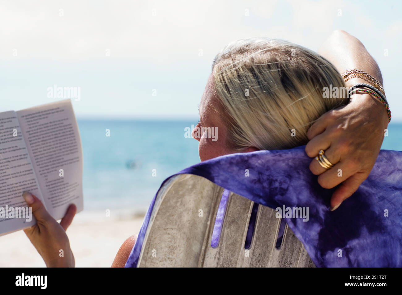 A woman reading a book at the beach Thailand Stock Photo - Alamy