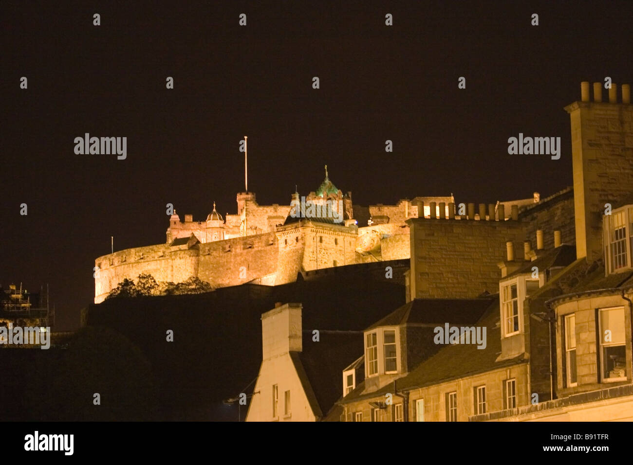 Illuminated Edinburgh castle above an Edinburgh street scene Stock ...