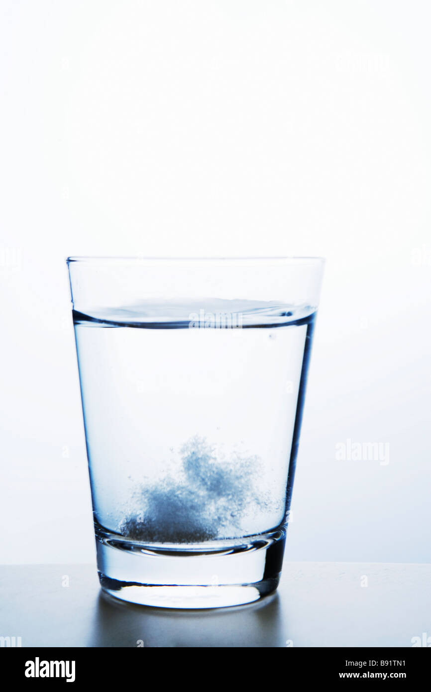 An effervescent tablet and a glass of water close-up Stock Photo - Alamy