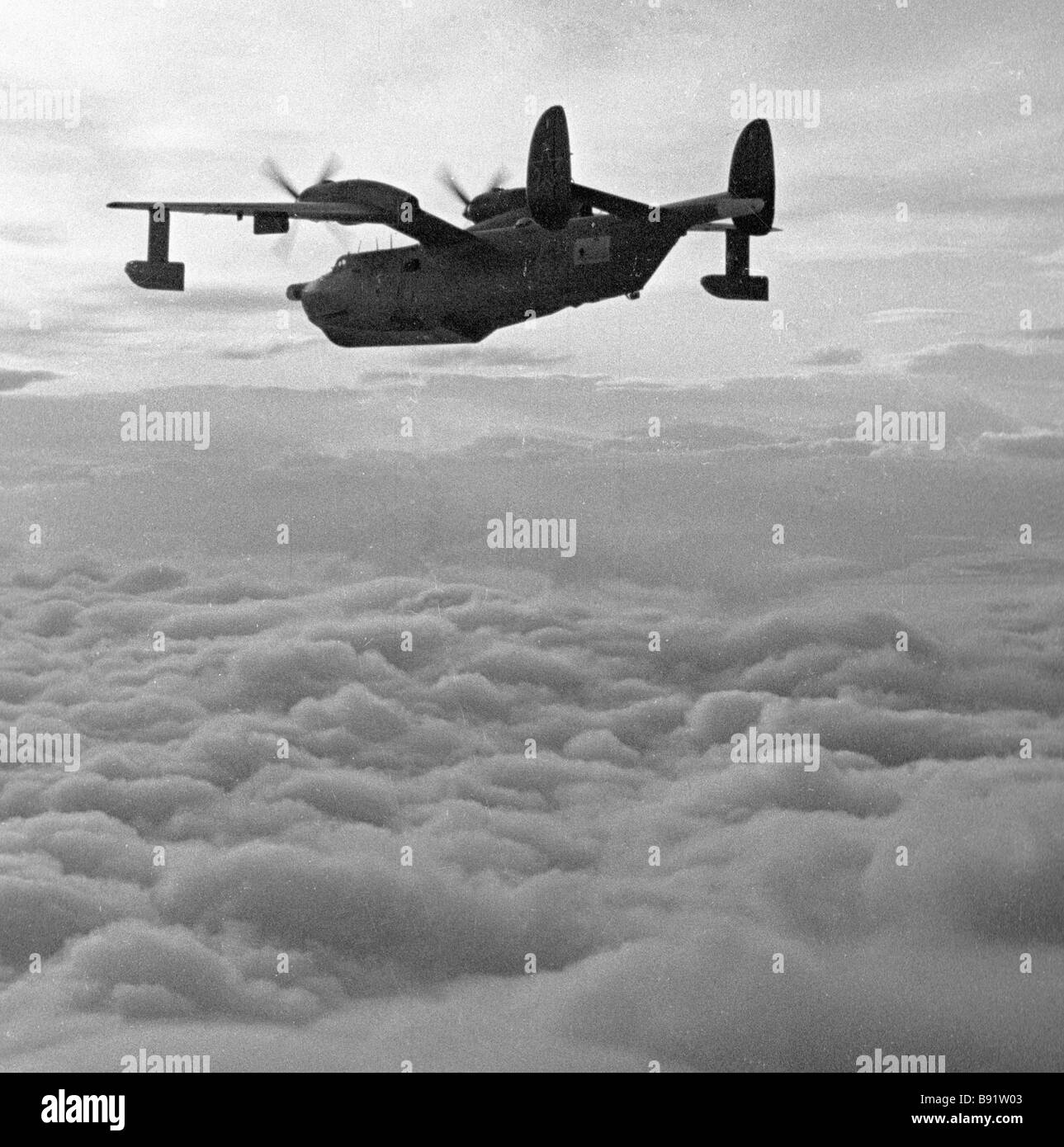 An amphibian aircraft flying above the clouds Stock Photo - Alamy